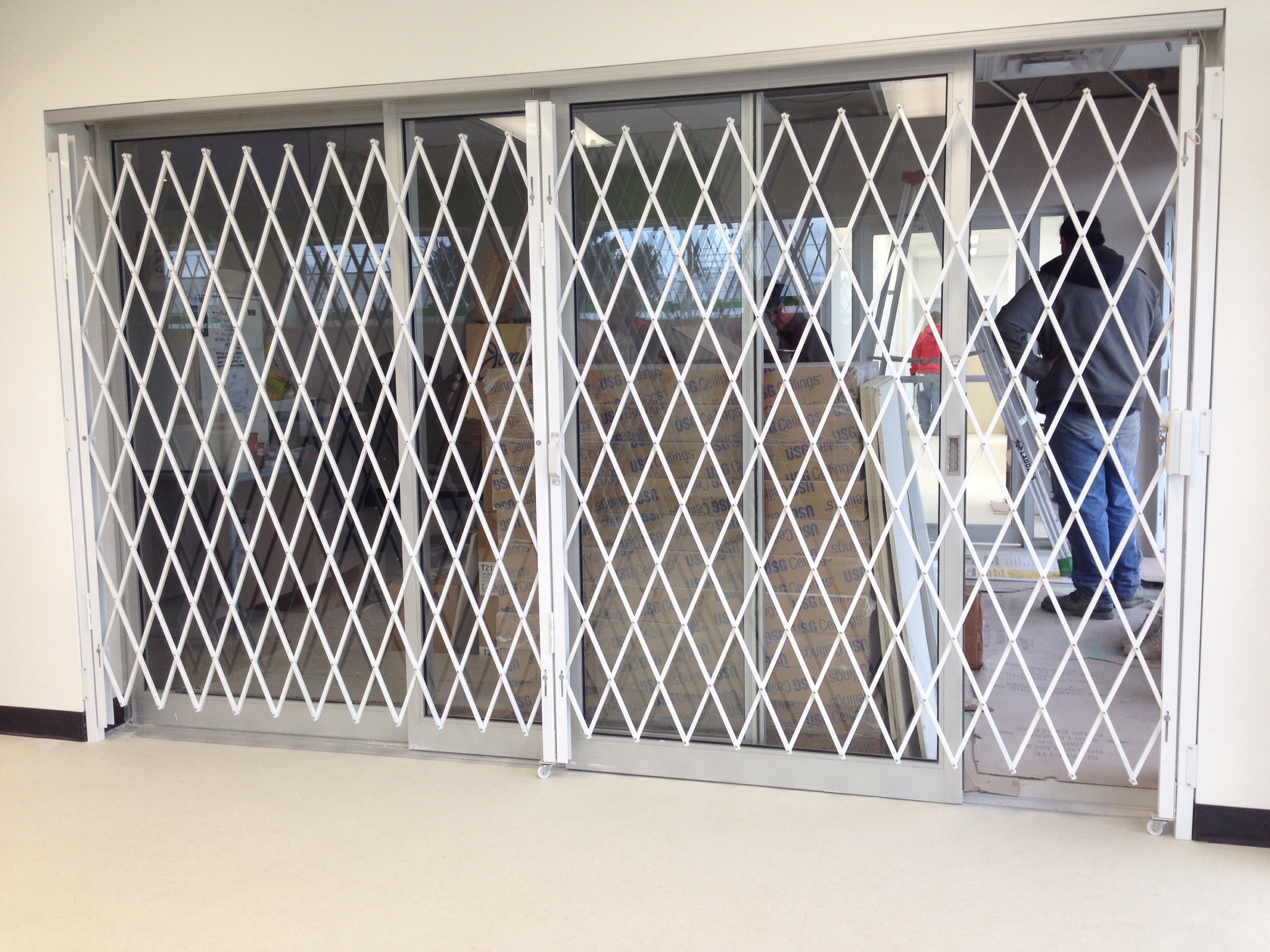 Folding security grilles, security closures, expansion grills